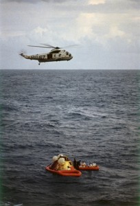 A recovery helicopter retrieves the crew of Apollo 8 after reentry ...