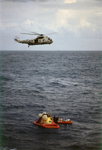 A recovery helicopter retrieves the crew of Apollo 8 after reentry ...