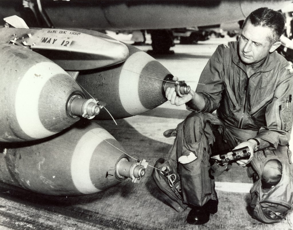 SCOTT, Robert Ray, Colonel, USAF, checks bombs while preflighting his F ...
